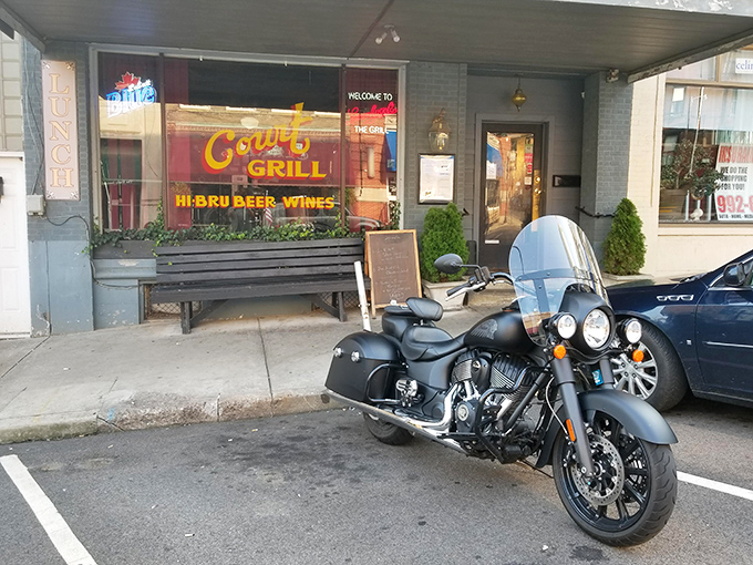 Court Street Grill welcomes hungry travelers with neon warmth. The motorcycle out front suggests the kind of place where stories are shared over plates of hearty comfort food.