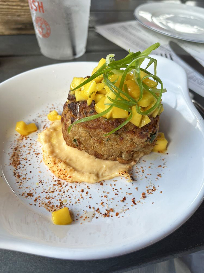This crab cake isn't hiding behind fillers and breadcrumbs &ndash; it's proudly showcasing its crabby personality with a mango salsa crown.