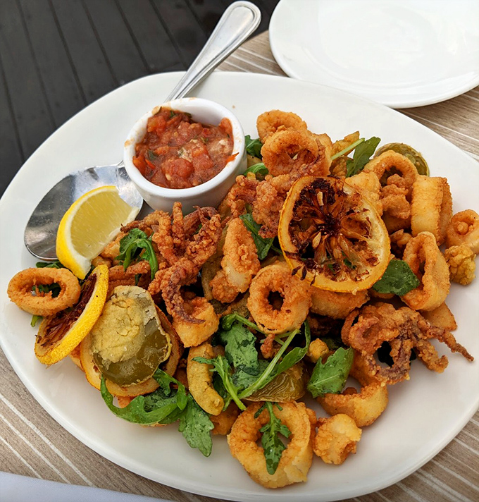 Calamari that defies the rubbery reputation of lesser versions&mdash;crispy, tender, and served with a squeeze of sunshine and herby greens.