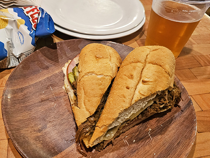 The Cuban sandwich arrives like two halves of a delicious story&mdash;crispy exterior, tender filling, and a side of cold beer that completes the narrative.