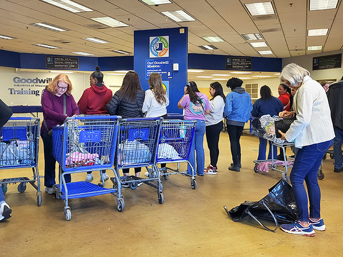 The anticipation is palpable as shoppers line up with their carts, ready for the next bin rotation. It's Black Friday energy on a random Tuesday morning.
