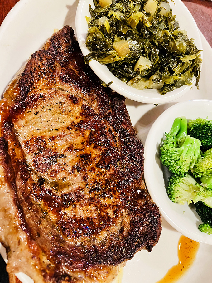 A steak so perfectly seared it deserves its own Instagram account, paired with greens that somehow make you feel virtuous about the protein-to-vegetable ratio.