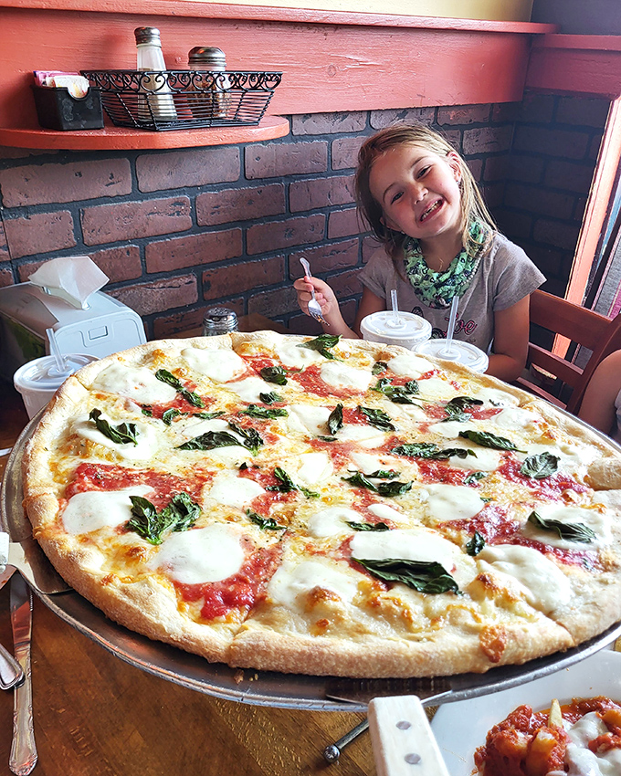 A Margherita pizza that could make a grown adult smile like a kid on Christmas morning. Fresh basil, melty mozzarella, and tomato sauce in perfect harmony.