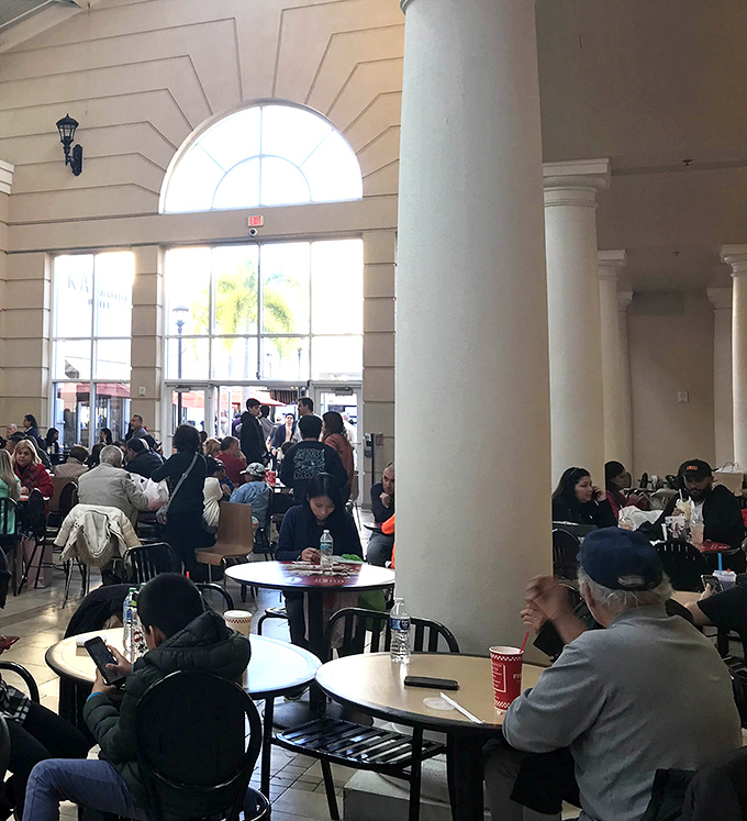 The food court becomes a United Nations of hungry shoppers, refueling before the next round of retail therapy.