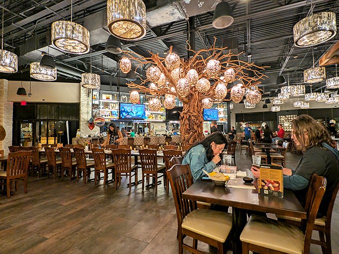 Beneath statement lighting fixtures and a showstopping wooden tree, diners enjoy meals that elevate mall dining far beyond food court territory.