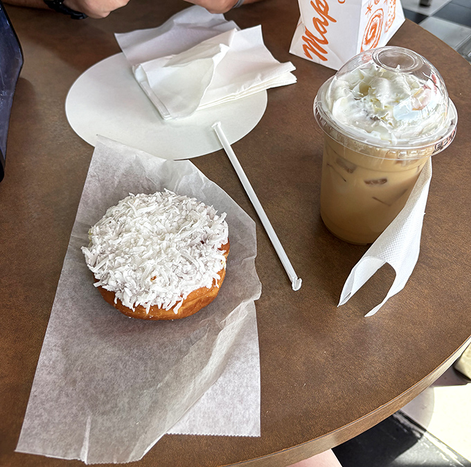The perfect pairing: a coconut-topped donut and iced coffee. Some relationships are just meant to be.
