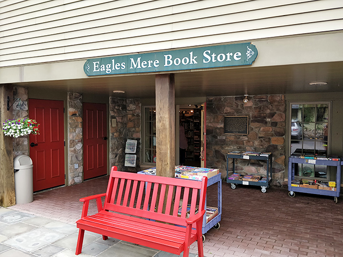 A red bench invites literary lingering outside Eagles Mere Book Store, where bestsellers meet small-town charm.