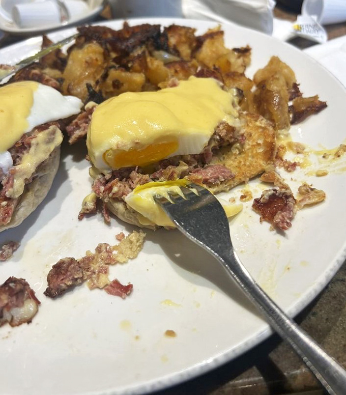 The holy breakfast trinity: perfectly poached eggs, savory meat, and home fries, all baptized in hollandaise and worth every delicious calorie.
