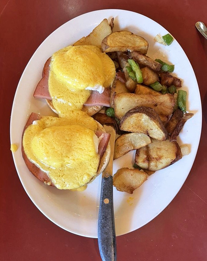 Eggs Benedict perfection&mdash;golden hollandaise cascading over Canadian bacon and English muffins with home fries that deserve their own fan club.