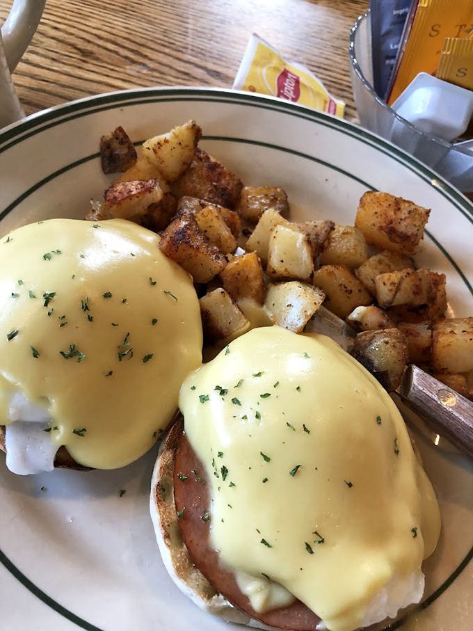 Eggs Benedict executed with textbook precision &ndash; that hollandaise sauce practically glows with lemony richness against golden home fries.