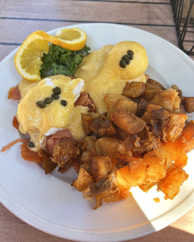 Eggs Benedict gets the Southern treatment with perfectly poached eggs, hollandaise, and home fries that make breakfast worth waking up for.