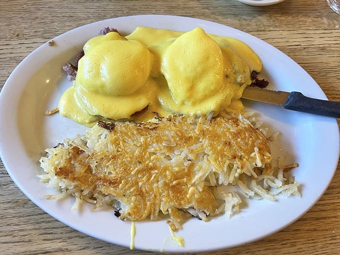 Eggs Benedict with hollandaise so sunny it practically creates its own weather system. Those hash browns are architectural marvels.