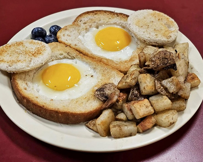 Eggs in a hole with home fries&mdash;breakfast engineering at its finest. Those sunny yolks are just waiting to break and create their own delicious sauce.