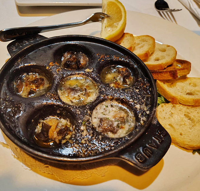 Escargot in cast iron, because even snails deserve the red carpet treatment when they're swimming in garlic butter.