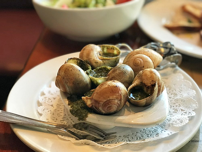 Escargot: The dish that turns "I could never eat snails" into "Can we order another plate?" Bathed in herb-garlic butter that demands bread for sopping.