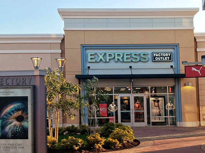 Express Factory Outlet glows invitingly at dusk, like a beacon for those seeking business casual attire without the business casual prices.