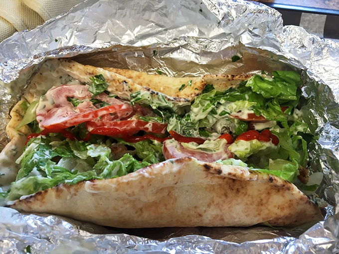 This falafel sandwich arrives wrapped like a gift, because that's essentially what perfectly crispy chickpea fritters are.