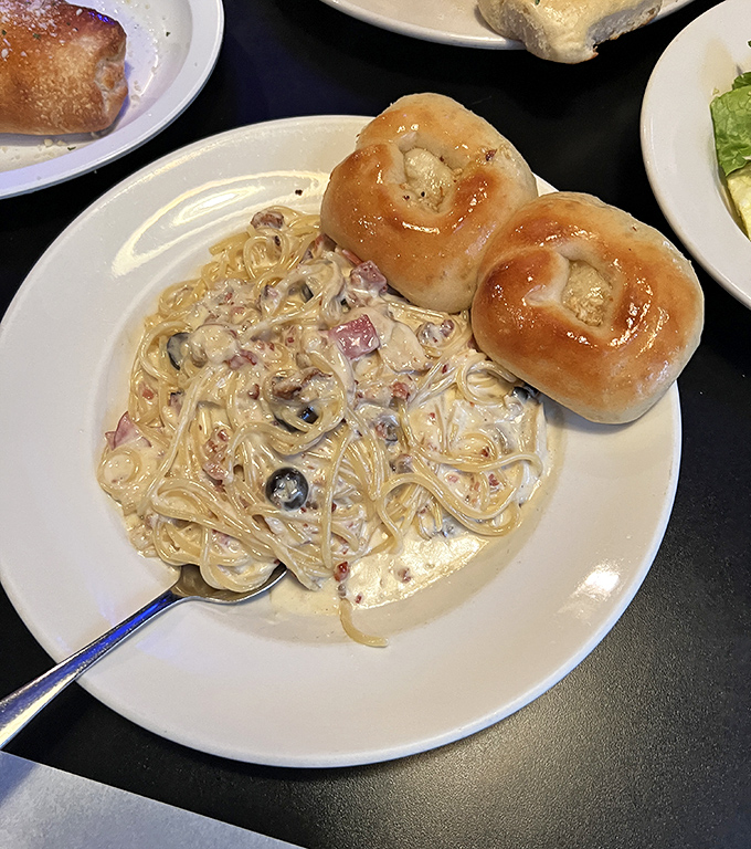 Fettuccine Alfredo with garlic knots &ndash; where cream sauce meets carbs in a romance more satisfying than any rom-com.