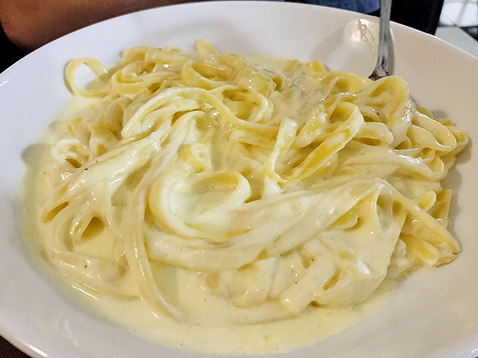 Fettuccine Alfredo so creamy it should come with its own cardiologist's business card &ndash; but worth every heavenly, indulgent bite.