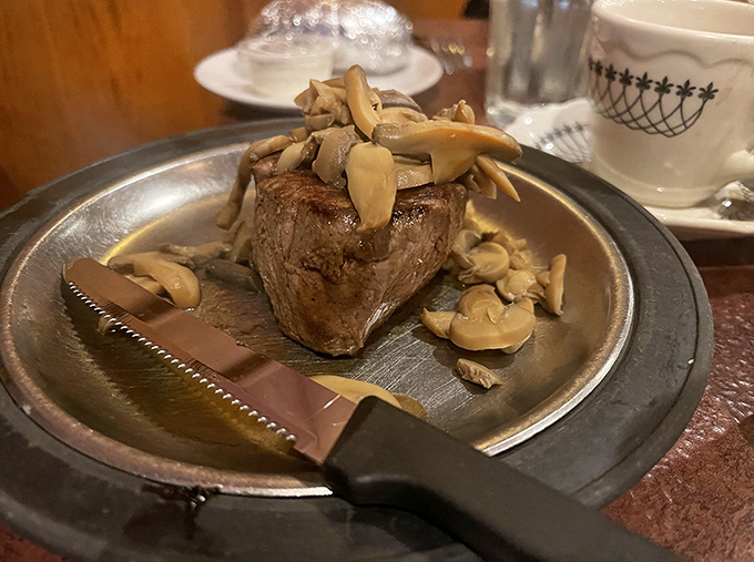 A filet mignon crowned with mushrooms that have found their purpose in life. That steak knife isn't just a utensil&mdash;it's a magic wand.