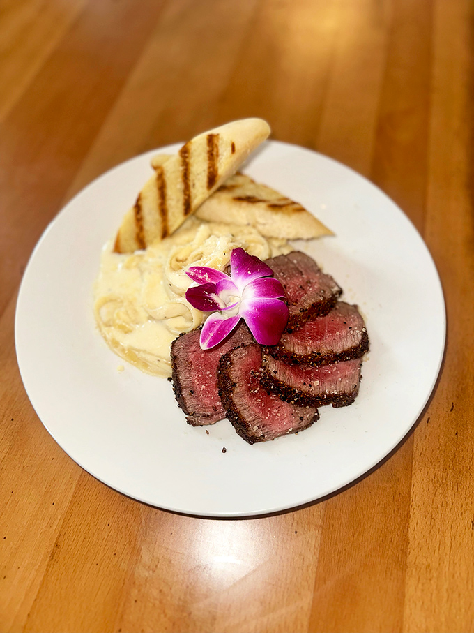When steak is presented with a purple orchid garnish, you know you're not in a typical roadside diner. This fillet mignon means serious business.