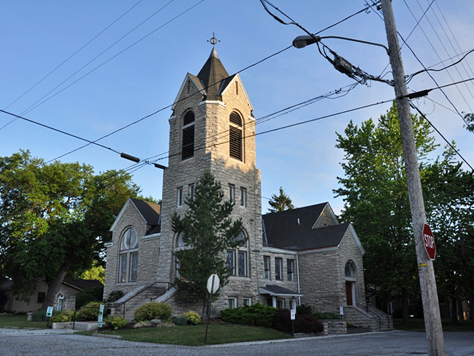 The First Congregational Church stands as a limestone testament to faith and craftsmanship, its tower reaching skyward like a sailor's prayer.