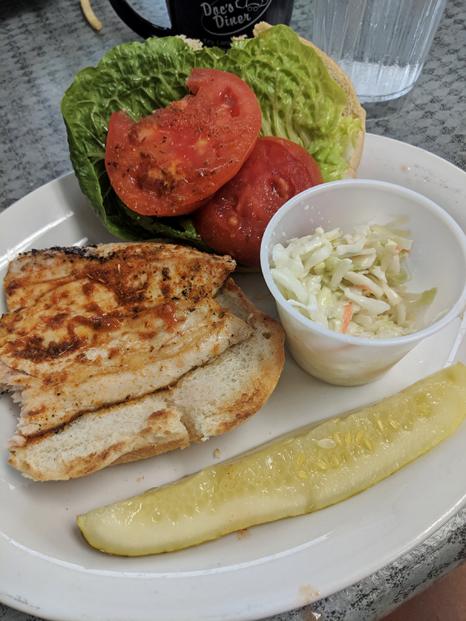 A grilled fish sandwich that tastes like it jumped from Gulf to griddle, paired with coleslaw that provides the perfect crisp counterpoint.