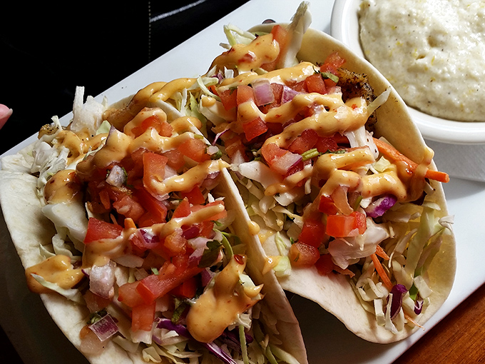 Fish tacos dressed for success with fresh cabbage, pico, and a sauce that should probably run for mayor.