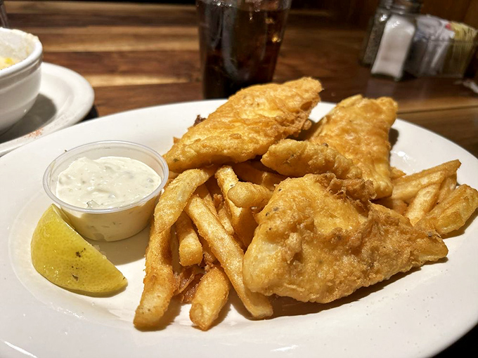 Fish and chips done right &ndash; golden, crispy batter protecting flaky white fish, with fries that clearly didn't come from a freezer bag.