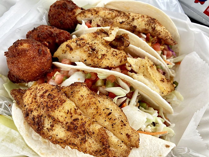 Fish tacos nestled in soft tortillas with crisp slaw—because sometimes the best coastal cuisine comes wrapped in handheld, mess-making glory that's worth every napkin.