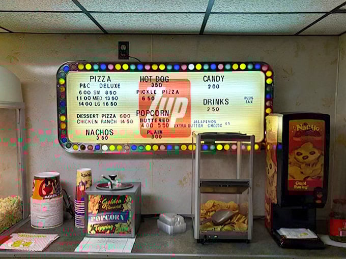 A menu board that hasn't changed much since "Jaws" was the summer blockbuster. Pizza, popcorn, and candy—the holy trinity of drive-in dining.