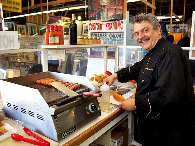 The hot dog maestro at work. In the symphony of market food vendors, this grill master conducts a perfect harmony of sizzle and satisfaction.