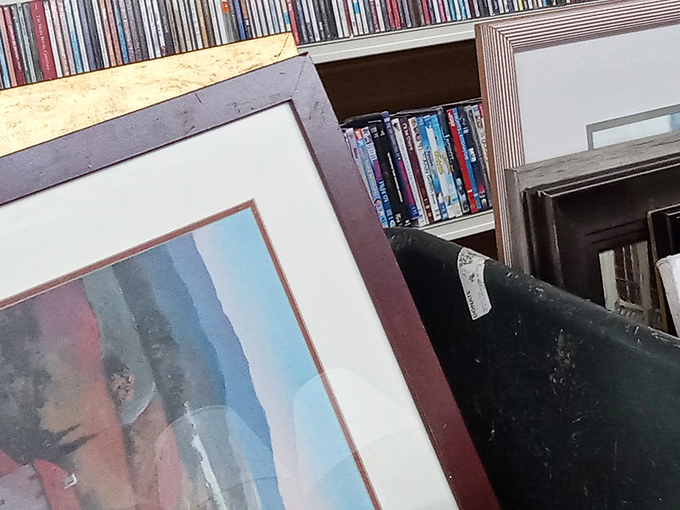 Art and entertainment treasures stacked like a gallery owner's garage sale. That framed piece might be your living room's missing statement.