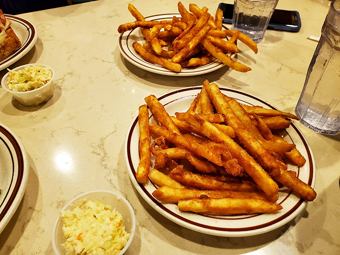 Golden, crispy French fries that achieve that perfect balance between exterior crunch and interior fluff. The side dish that frequently steals the show.