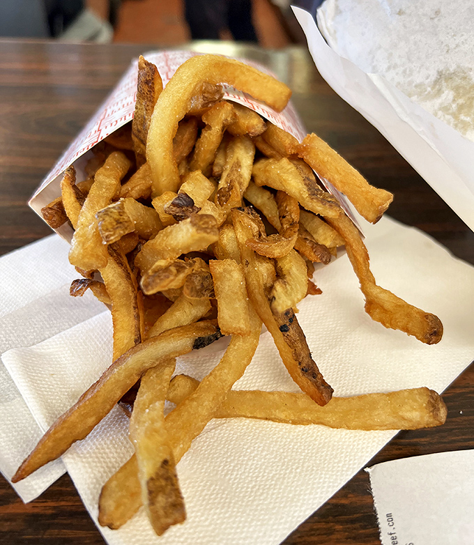 Hand-cut fries that achieve the golden trifecta: crispy exterior, fluffy interior, and just enough salt to make your cardiologist nervous.