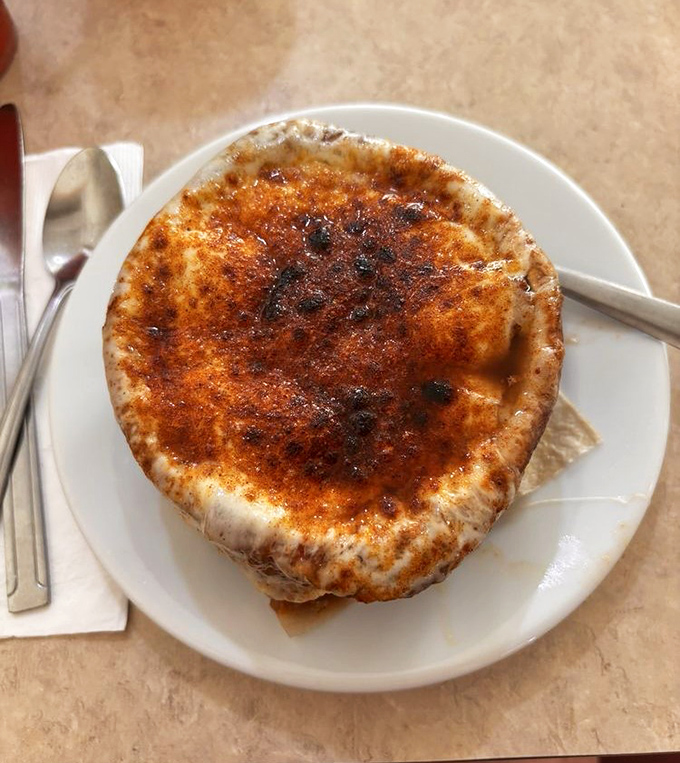French onion soup with a caramelized crust that requires a satisfying crack of the spoon&mdash;like cr&egrave;me br&ucirc;l&eacute;e's savory, more substantial cousin.