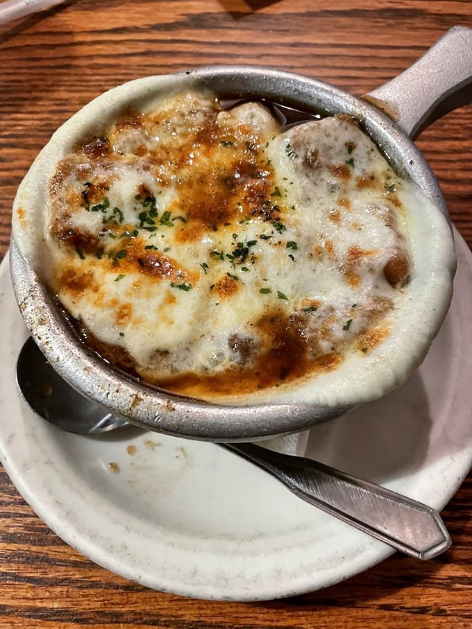 French onion soup that's achieved the golden trifecta: sweet caramelized onions, rich broth, and that glorious cap of melted cheese that stretches with each spoonful.