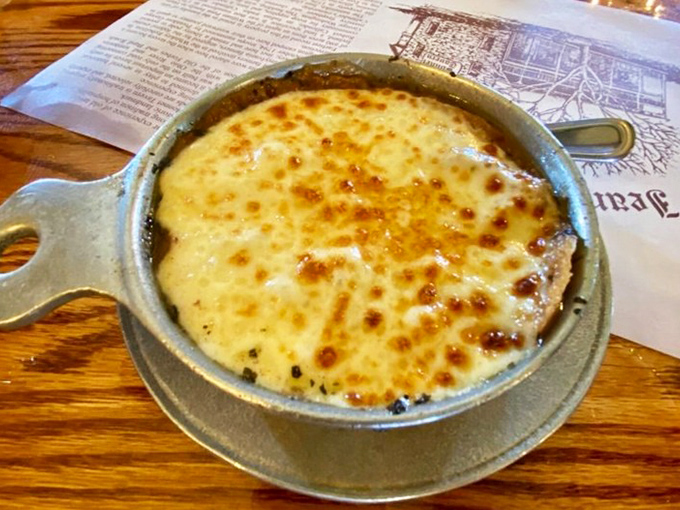 French onion soup with a cheese pull that deserves its own slow-motion sequence. Comfort in a crock that warms you from the inside out.