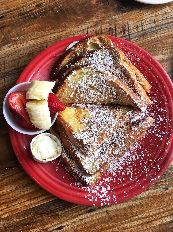 French toast that's dressed for success&mdash;powdered sugar snow, fresh fruit accessories, and that golden-brown exterior that whispers, "Yes, this is worth the calories."