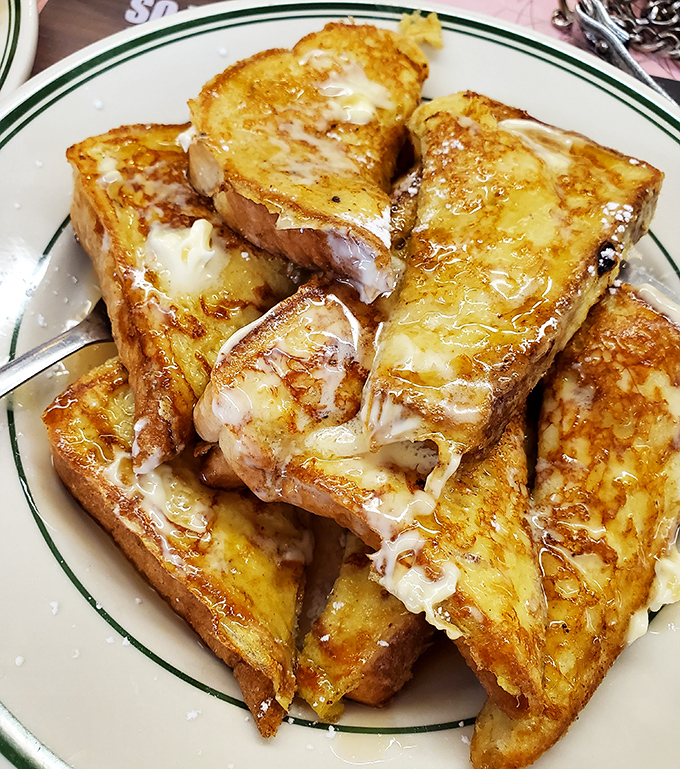 French toast stacked like delicious Jenga blocks. The syrup-soaked pieces glisten with buttery promise that would make your cardiologist nervous.