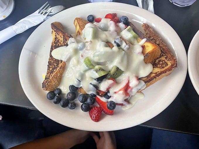 French toast that doesn't need a passport to impress, topped with enough fresh fruit to convince yourself it's practically a health food.