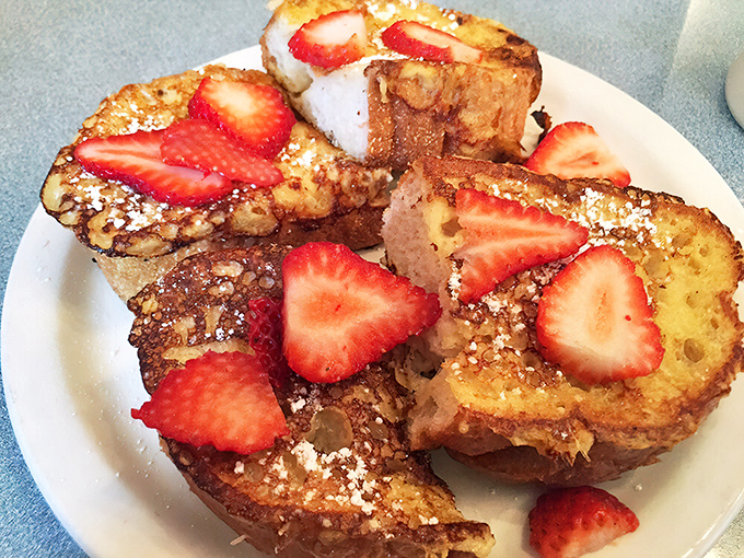 French toast that makes you question all other breakfast choices&mdash;golden, crisp edges giving way to custardy centers, crowned with fresh strawberries.
