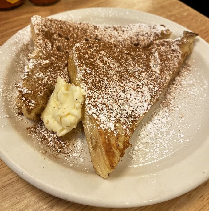French toast dusted with powdered sugar and sporting a dollop of butter – simple perfection that doesn't need Instagram filters to impress.