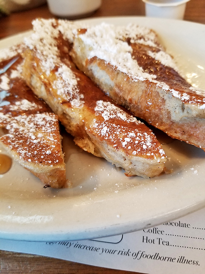 French toast that makes you understand why breakfast deserves its "most important meal" status. Powdered sugar snowfall included.