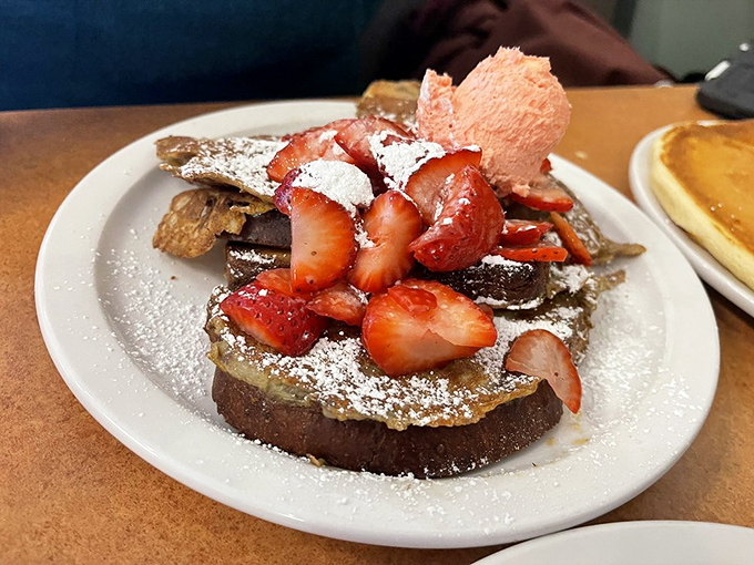 French toast that's having a strawberry party – powdered sugar snowfall included, no RSVP required.