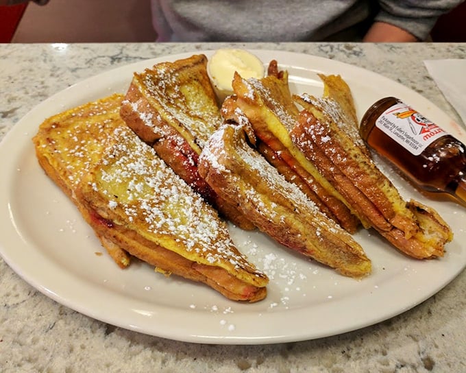 French toast that transforms ordinary bread into a custard-soaked miracle, dusted with powdered sugar like fresh New England snow.