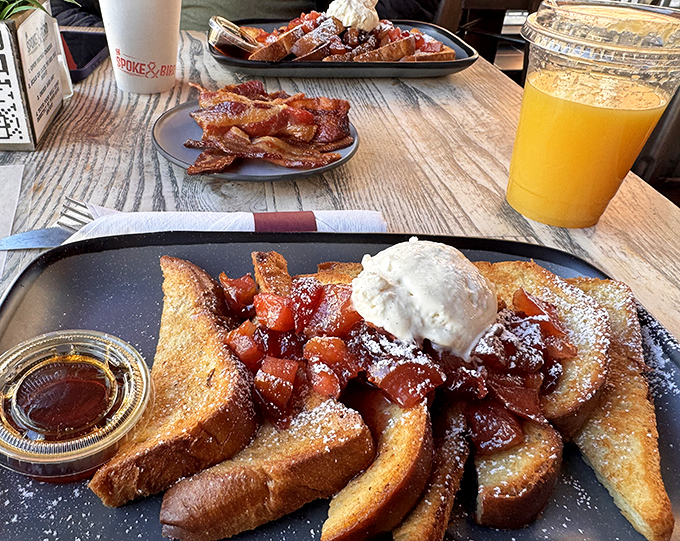 French toast that's dressed better than most people at brunch, topped with what appears to be cinnamon-spiced apples and a dollop of pure joy.