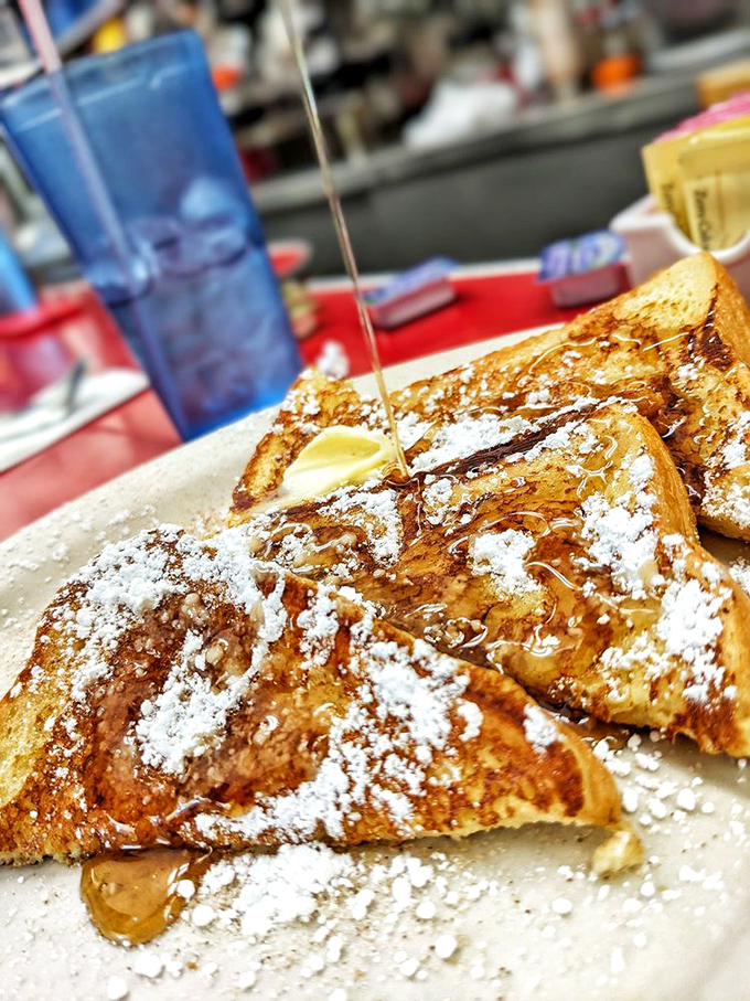 French toast dusted with powdered sugar and drizzled with maple syrup&mdash;proof that sometimes the simplest pleasures are worth getting out of bed for.