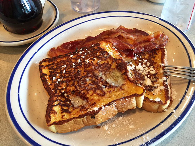 French toast that clearly went to finishing school. With bacon standing guard and eggs keeping watch, this breakfast trinity is practically patriotic.