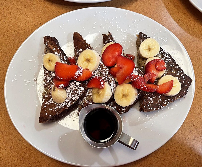 French toast so photogenic it should have its own Instagram account, dressed to the nines in berries and powdered sugar.
